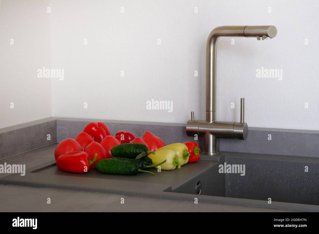 Sink with colorful vegetables in kitchen room. Modern counter with sink ...
