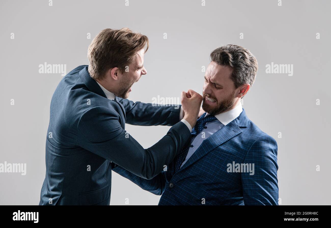 two angry businessmen punching in fight and arguing having struggle for ...