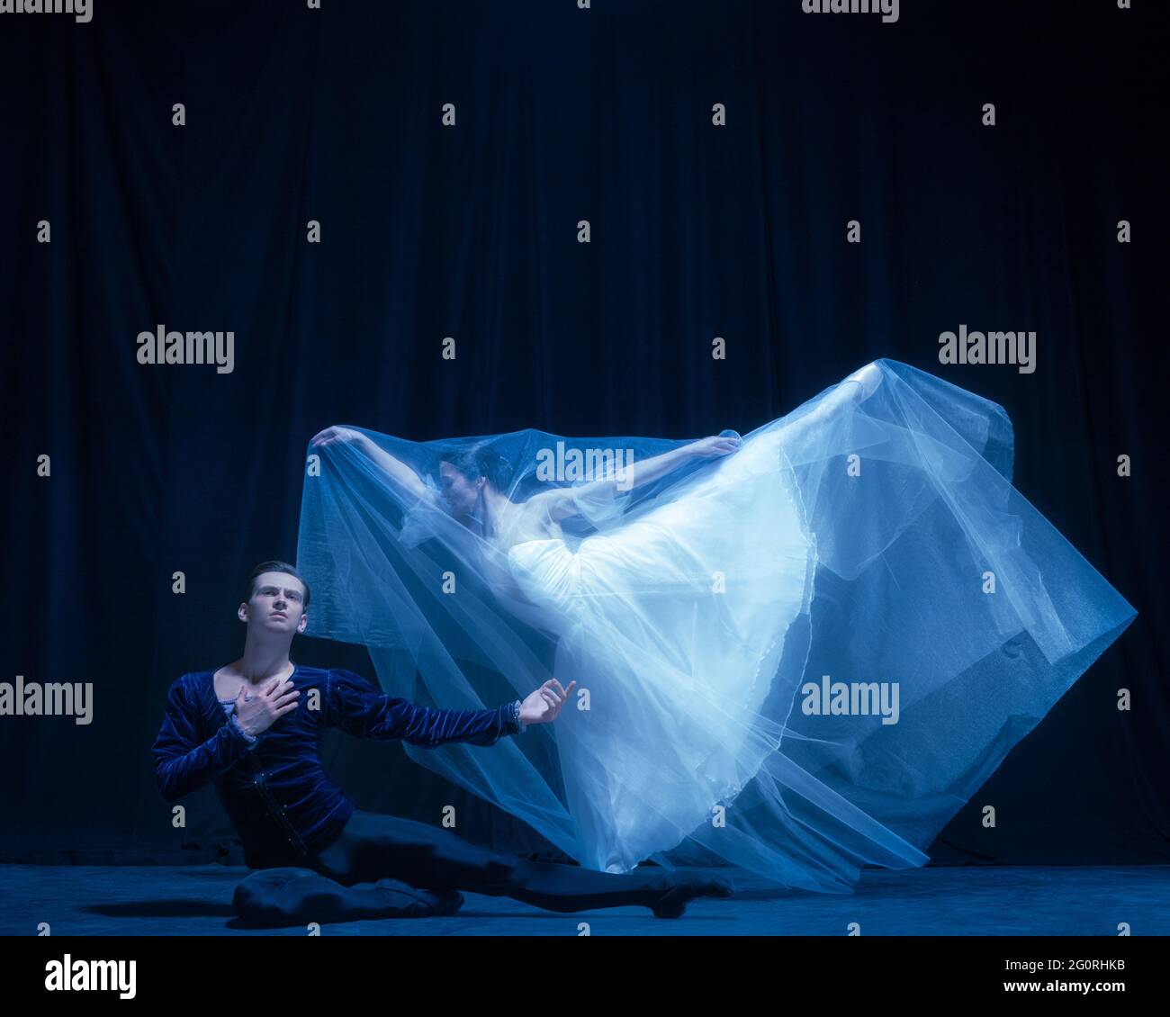 Art performance. Two graceful ballet dancers, man and woman dancing ...