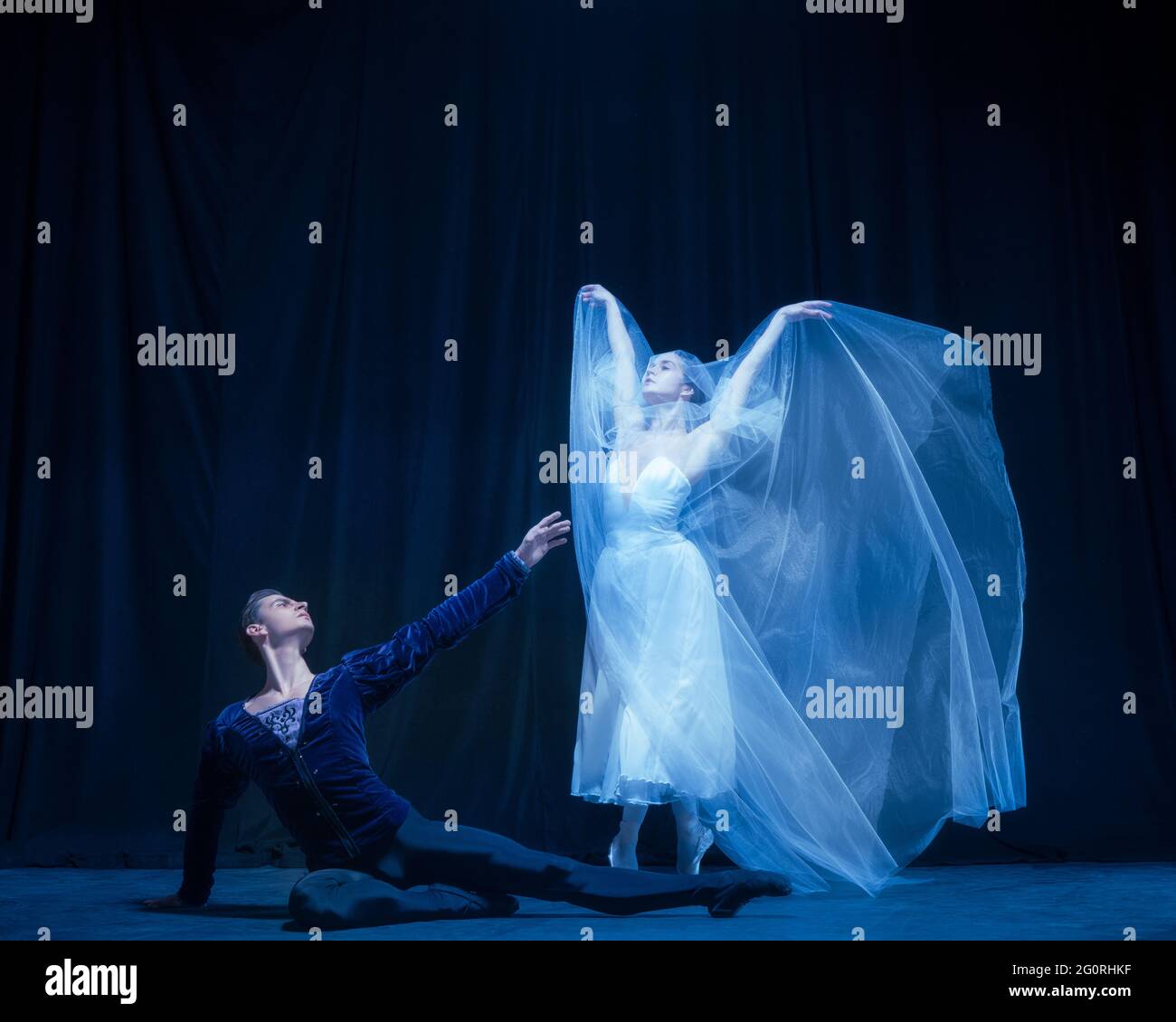 Art performance. Two graceful ballet dancers, man and woman dancing ...
