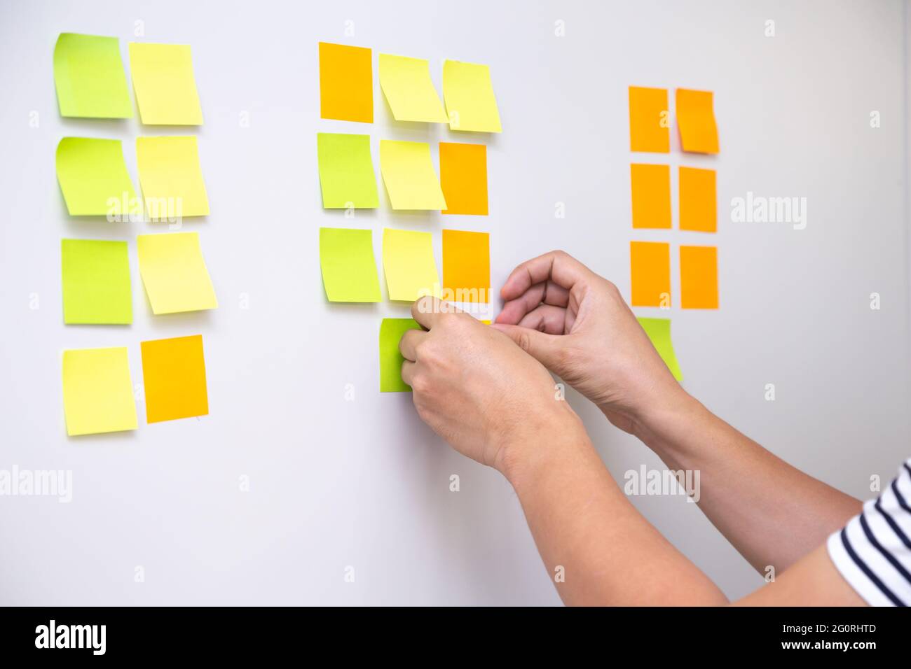 IT worker tracking his tasks on kanban board. Using task control of ...