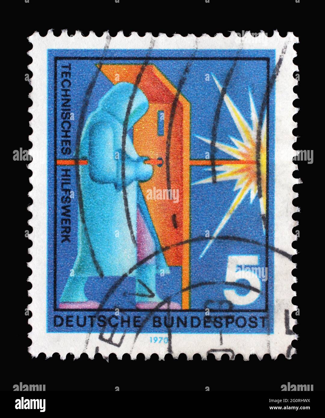 Stamp printed in Germany showing a welder with a protective suit ...