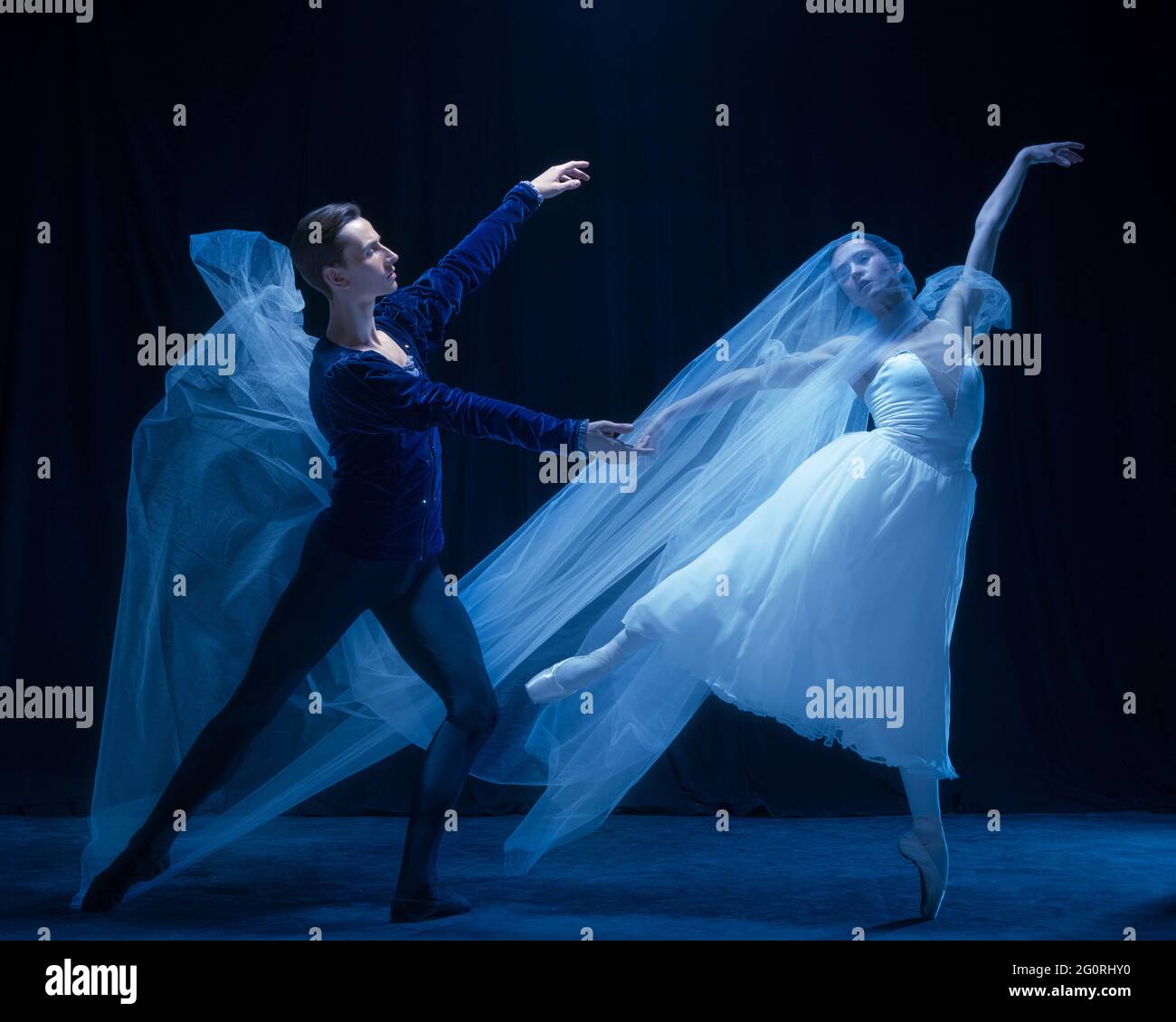 Art performance. Two graceful ballet dancers, man and woman dancing ...