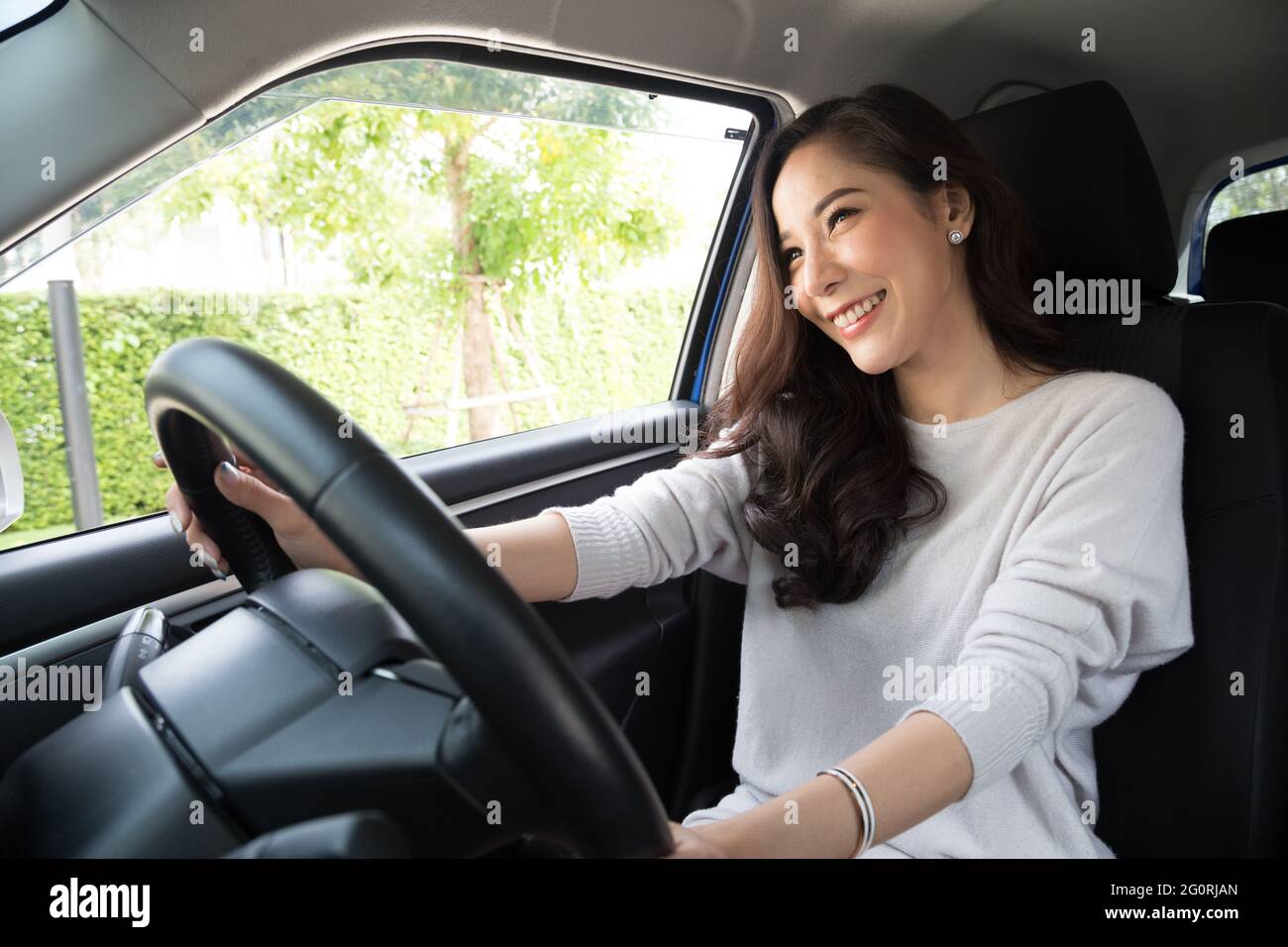 Asian women driving a car and smile happily with glad positive ...