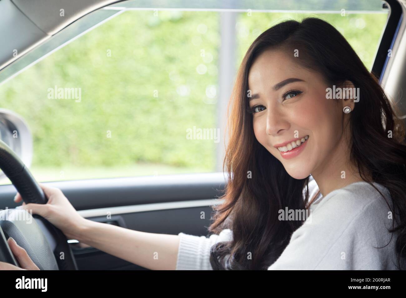 Asian women driving a car and smile happily with glad positive ...