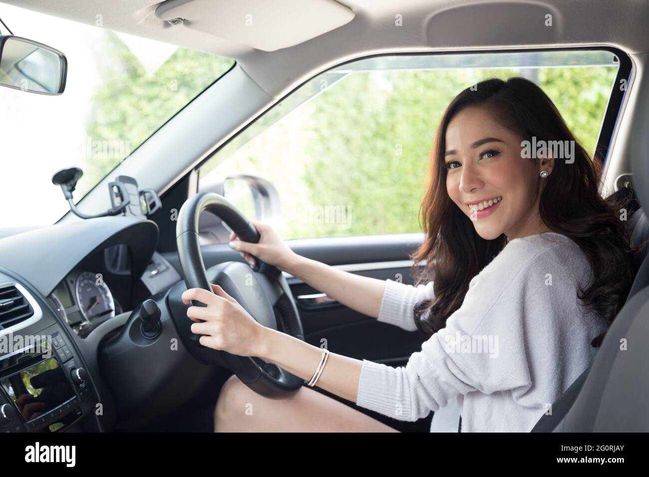Asian women driving a car and smile happily with glad positive ...