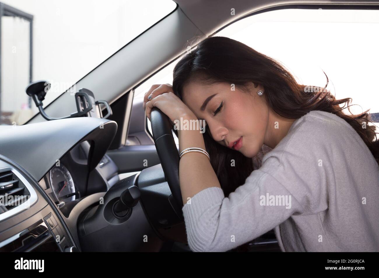 Tired young woman sleep in car, Hard work causes poor health, Sit ...