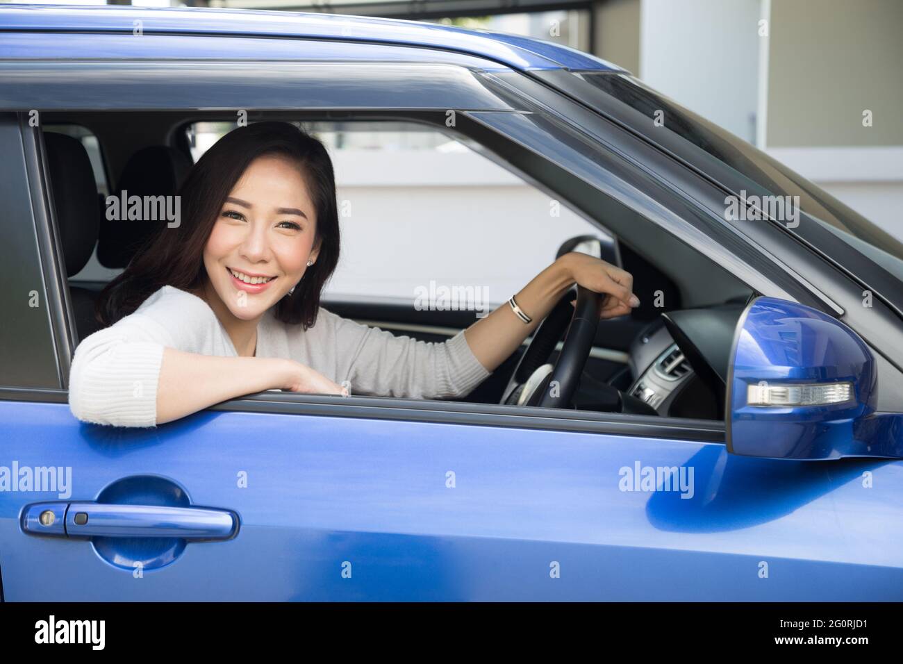 Asian women driving a car and smile happily with glad positive ...