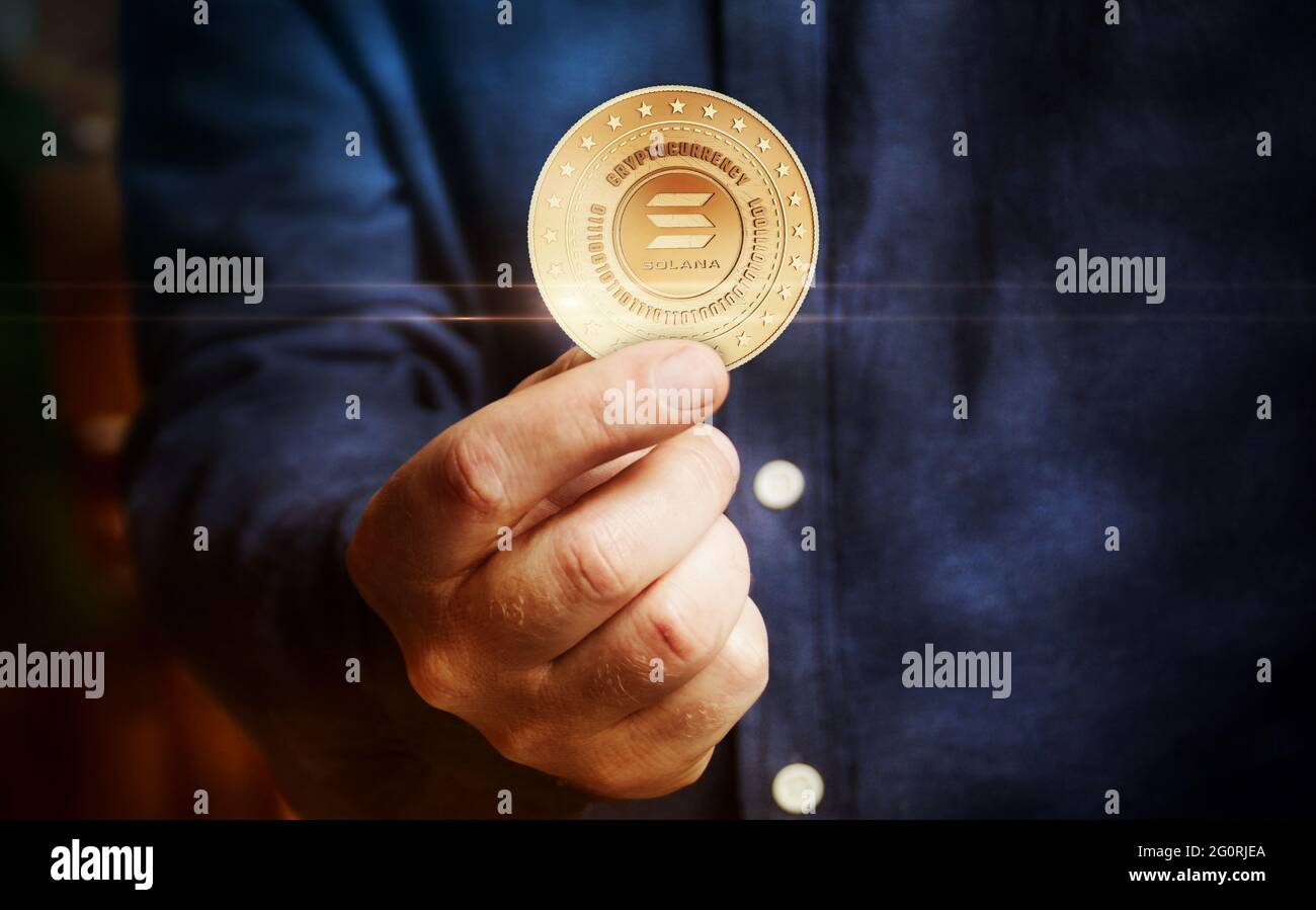Solana altcoin cryptocurrency symbol golden coin in hand abstract ...