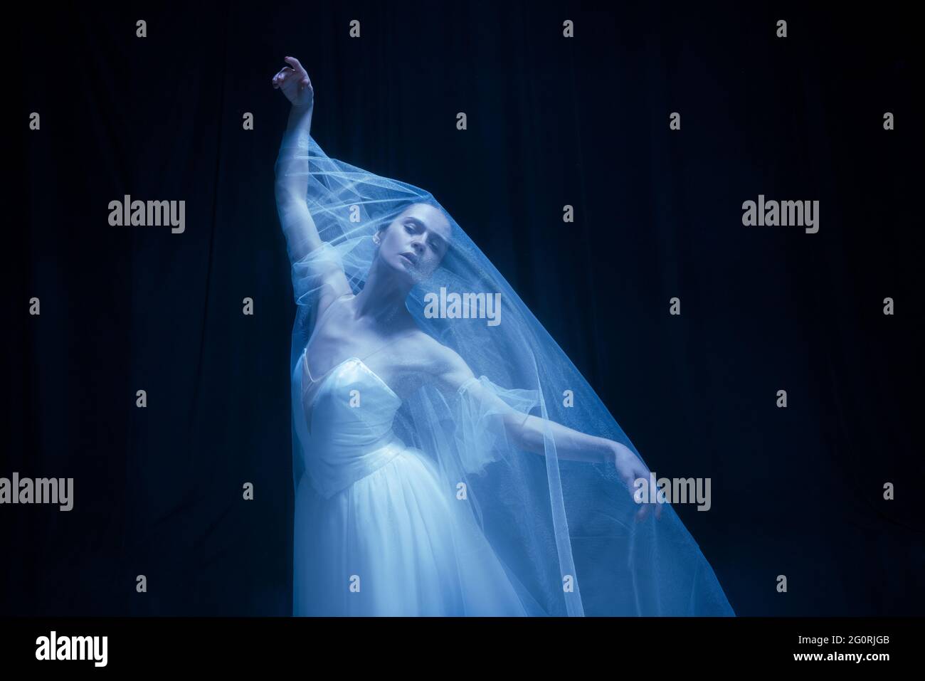 Loneliness. Young graceful beautiful woman, balerina in white wedding ...
