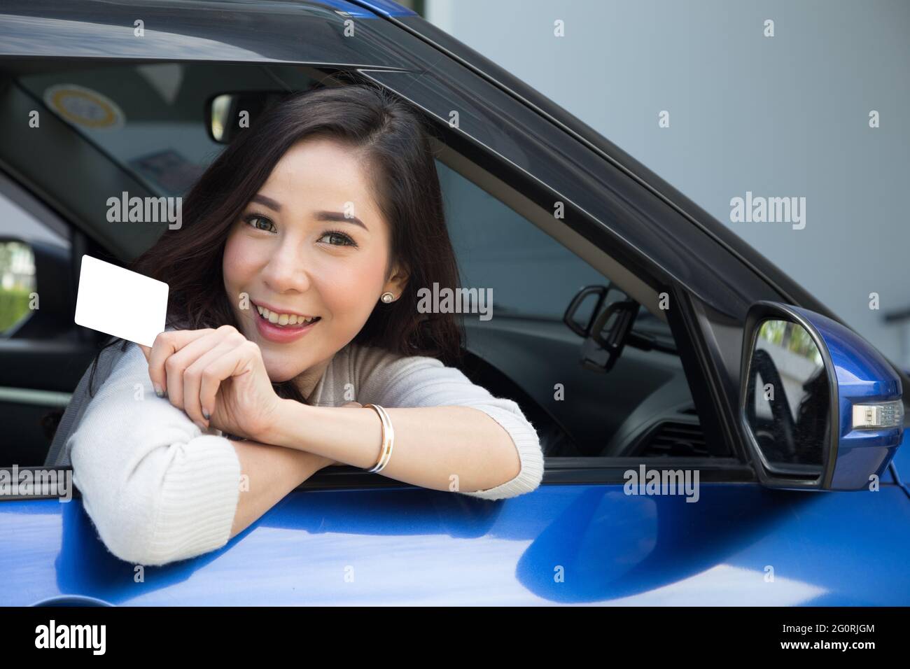 Asian woman holding personal accident insurance card and sitting in ...
