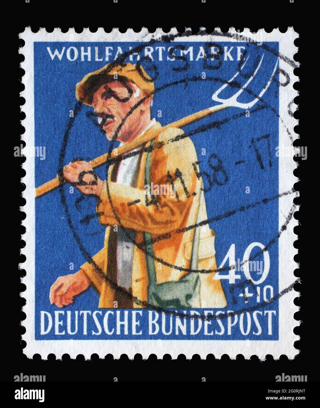 Stamp printed in Germany shows Farmer with pitchfork, circa 1958 Stock ...
