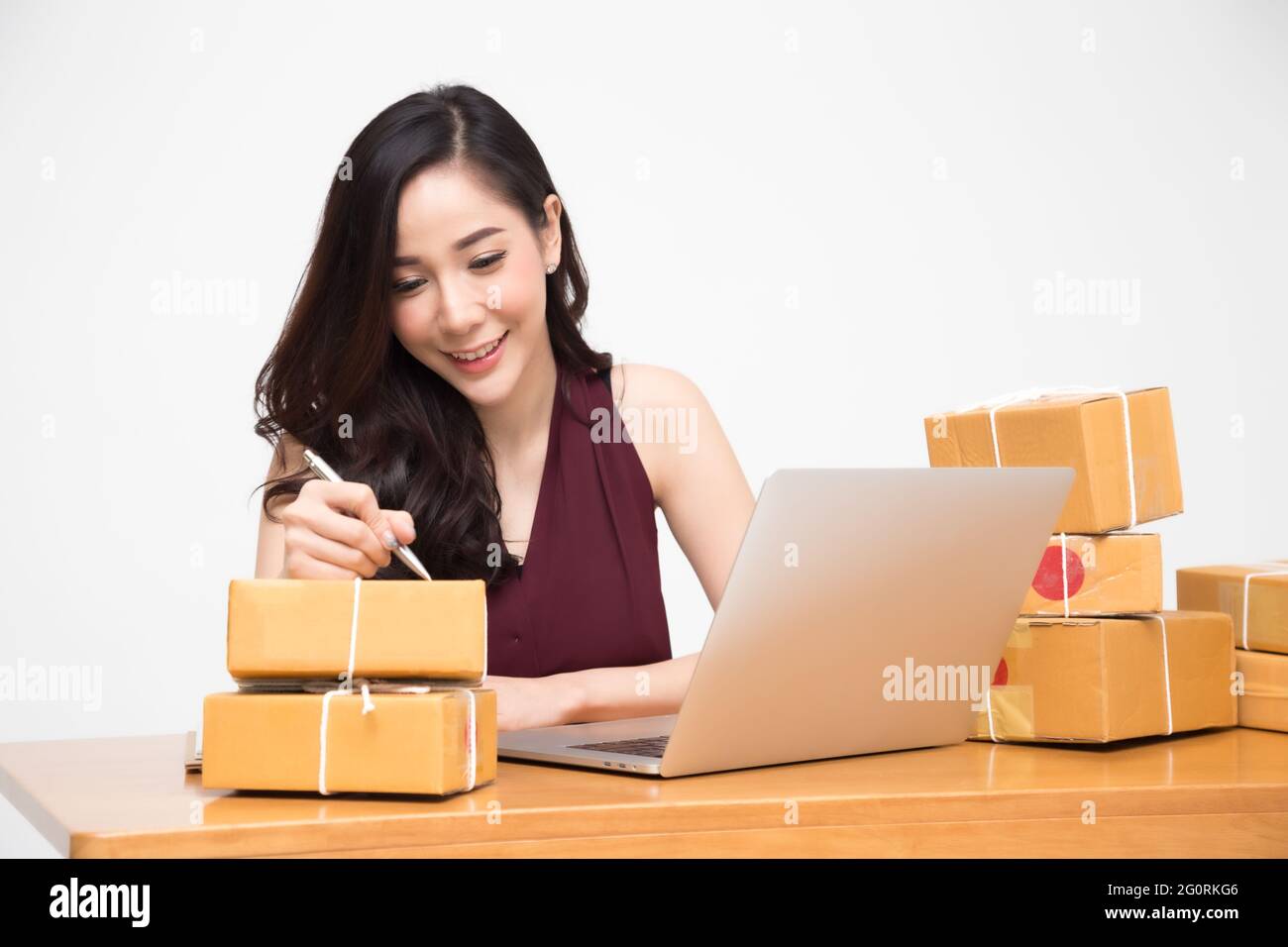 Asian women packing parcel on the table and white background, Female ...