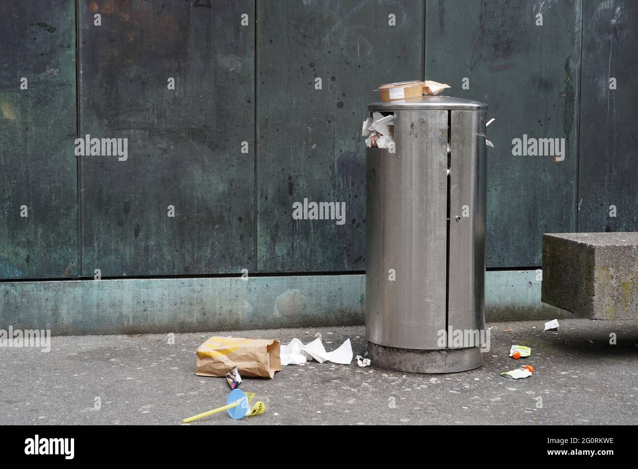Food rubbish in and around public rubbish bin in the street Stock Photo ...