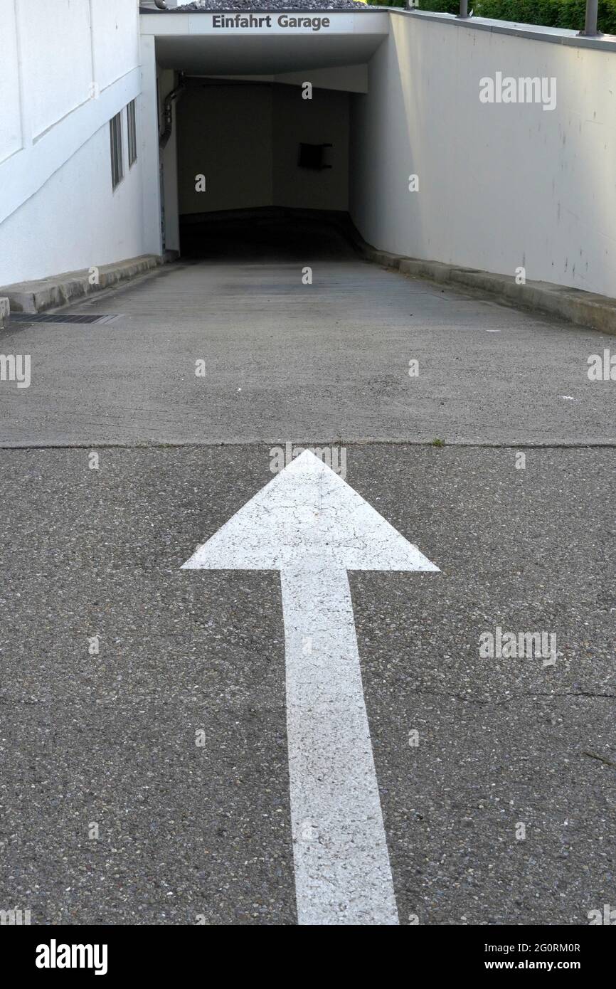Entrance to an underground parking with a white arrow showing direction ...