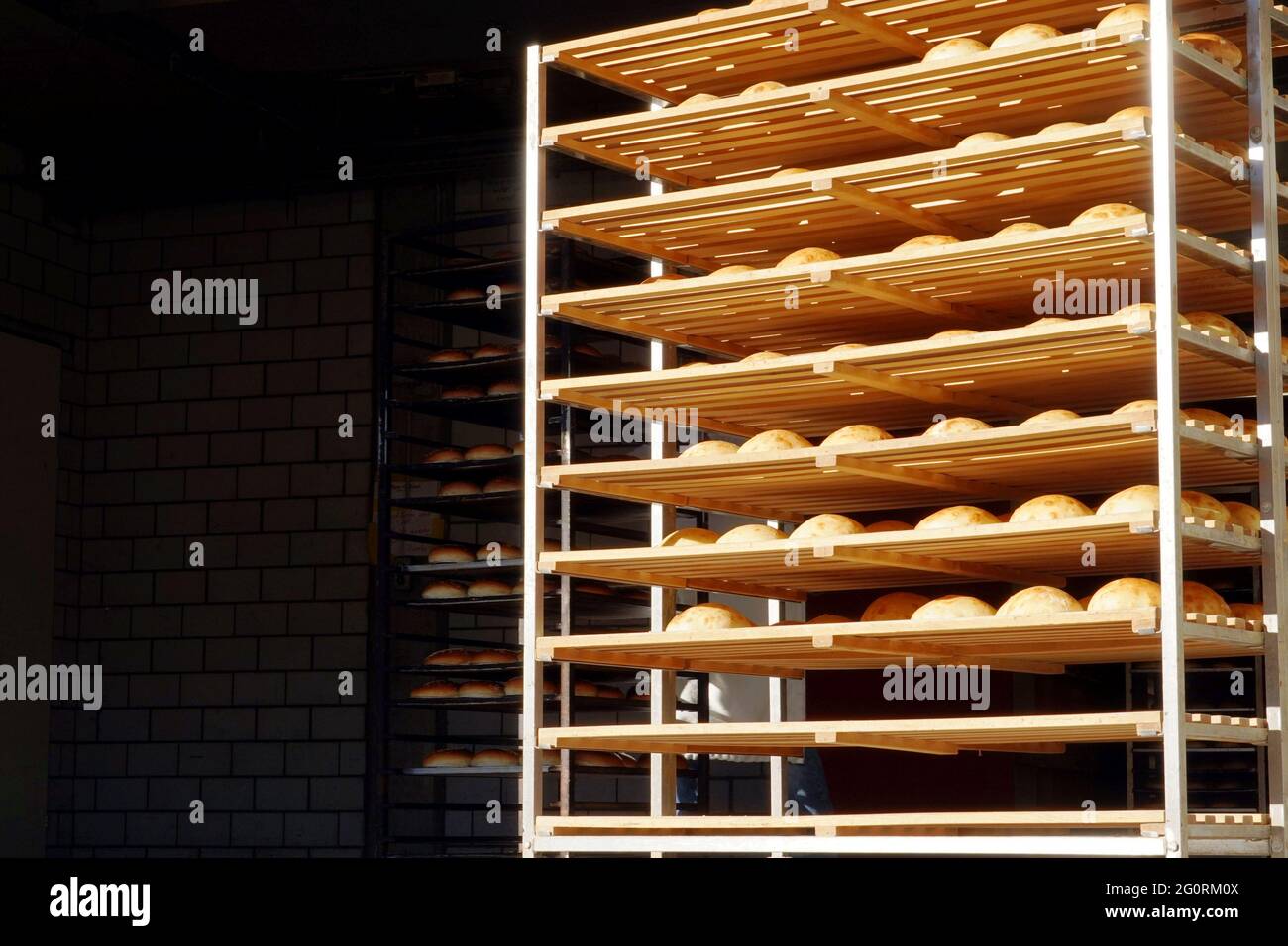 Fresh bread on mobile rack with shelves. The bread is outdoors to cool ...