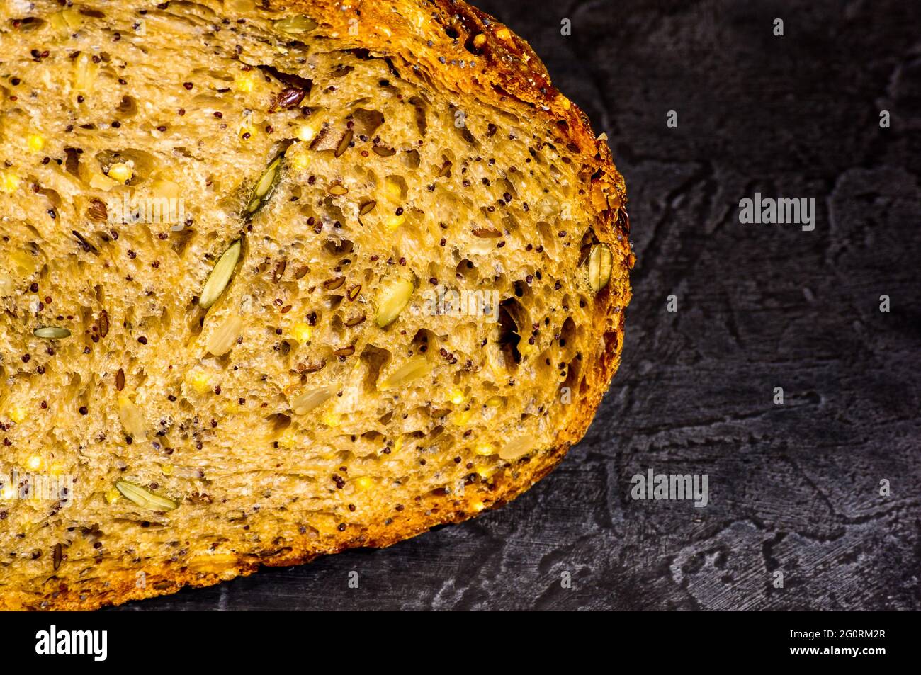 Slice of rustic natural yeast-free bread with flax, poppy seeds, sesame ...