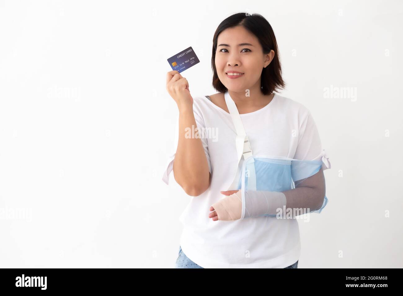 Asian woman holding credit card and put on a soft splint due to a ...