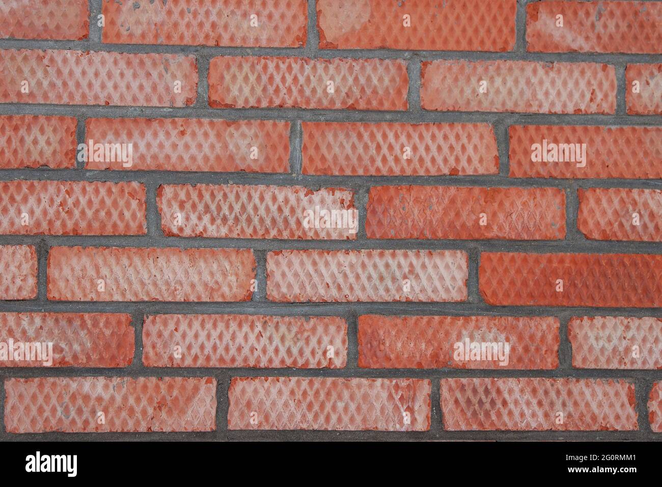 Red brick wall made of corrugated construction bricks. Background image ...