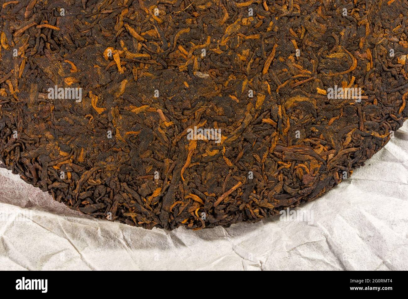 Chinese pressed PU-erh tea on wrapping paper, close-up Stock Photo - Alamy