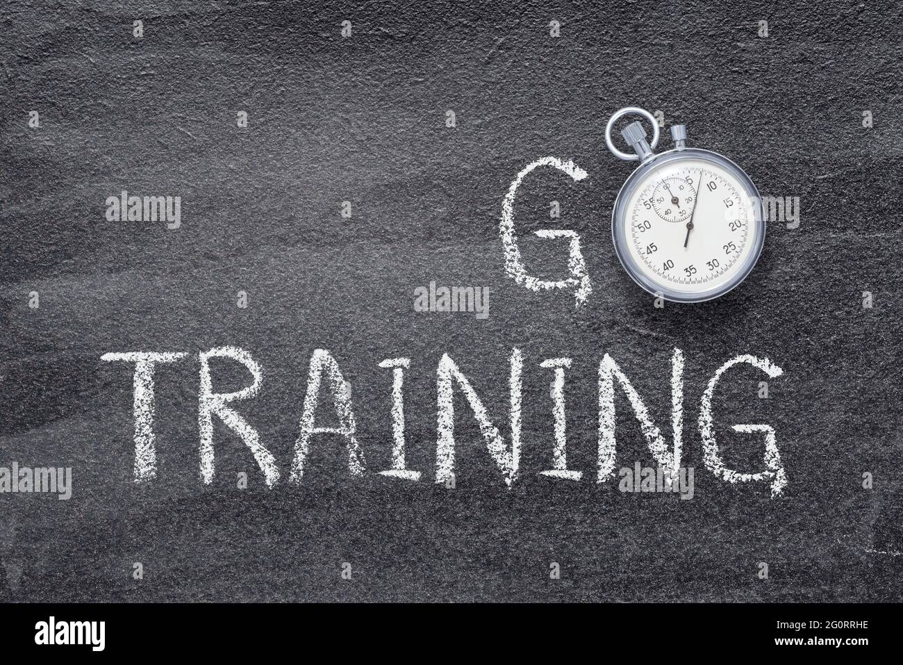 go training slogan written on chalkboard with vintage precise stopwatch ...