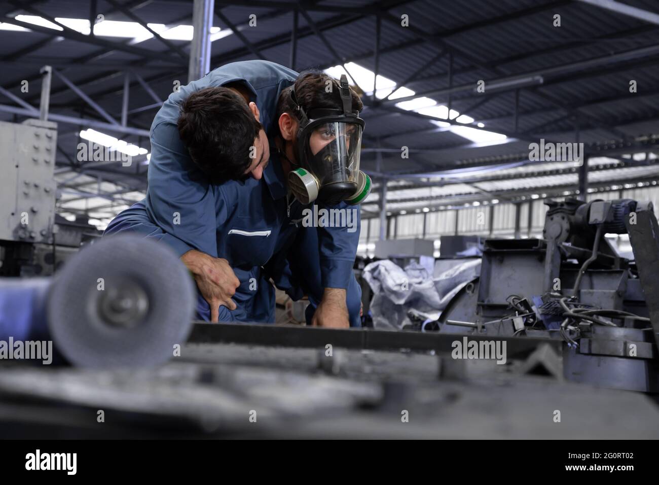Industrial engineer carrying on back colleagues while chemical spills ...