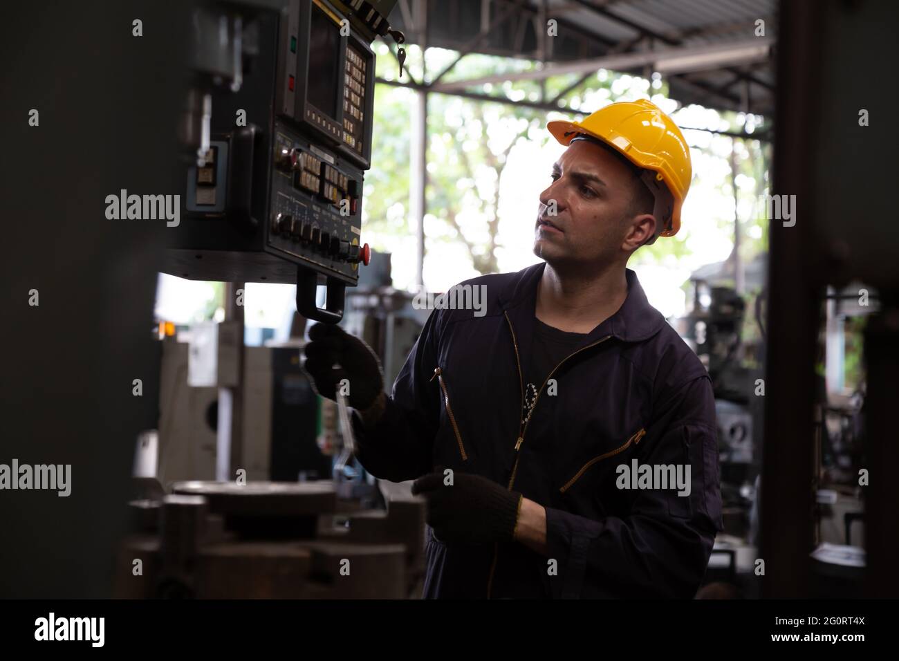 Heavy industrial worker is working on metal work factory, Machine for ...