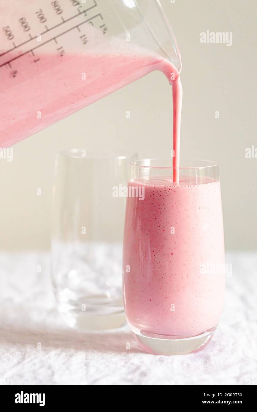 Pouring strawberry milk shake in glass hi-res stock photography and ...