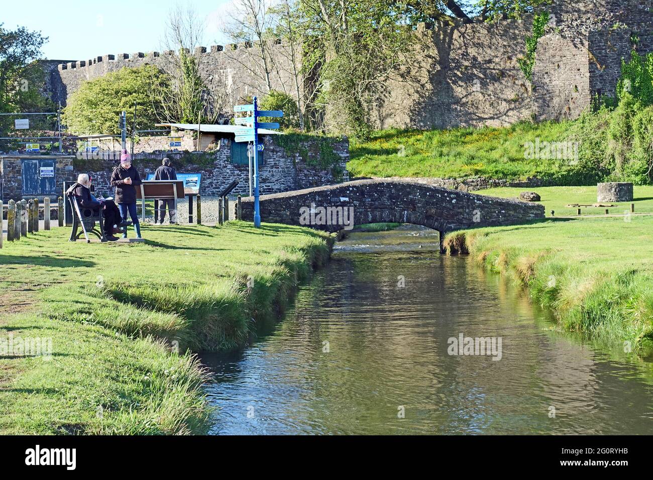 Old stone footbridge over the River Coran, Laugharne Castle ...