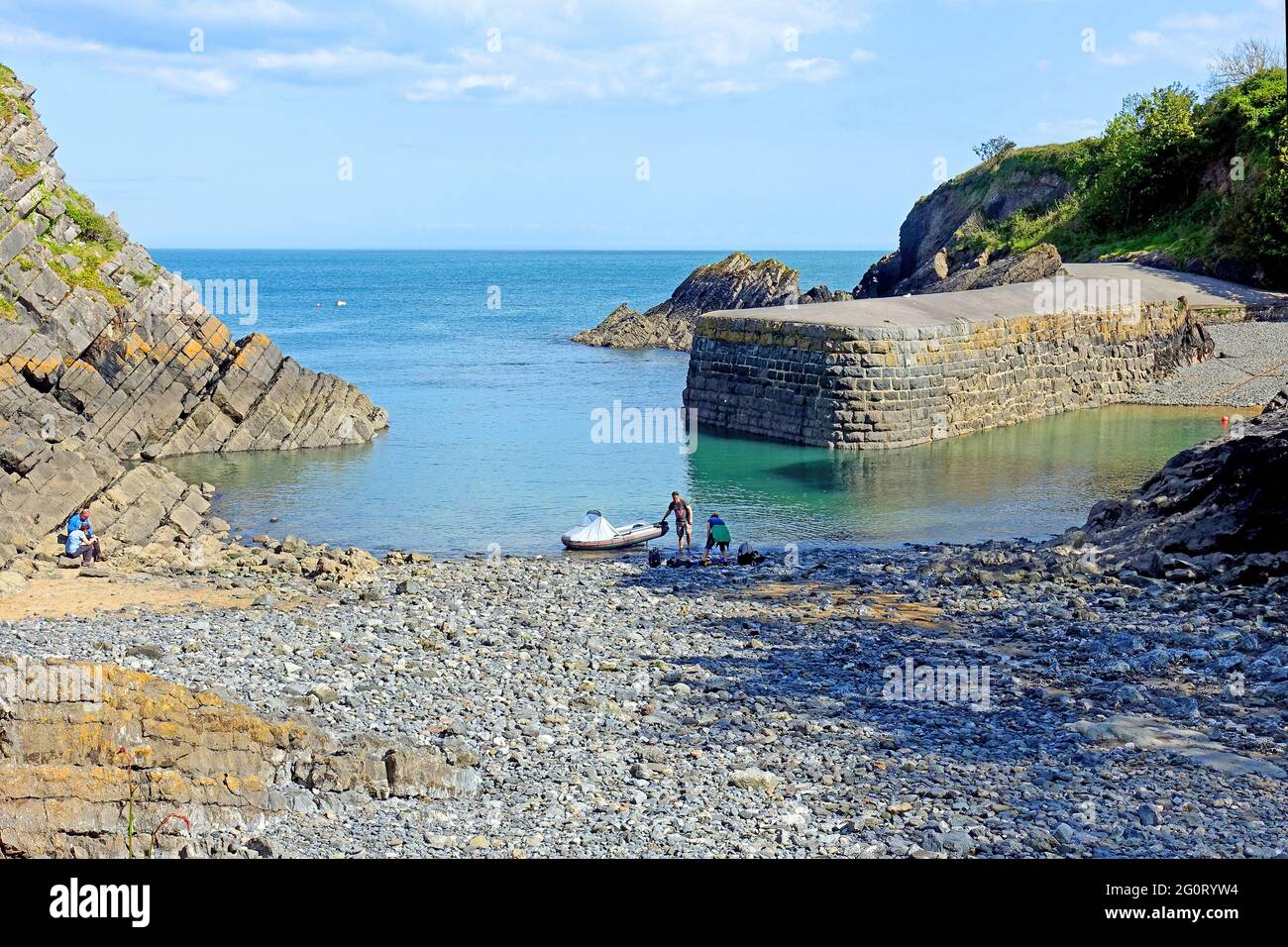 Dinghy launching at the tiny harbour of Stackpole Quay, Pembrokeshire ...