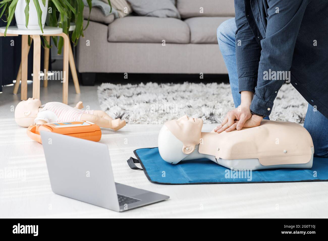 Paramedic demonstrating first aid on manikin during training alone in ...