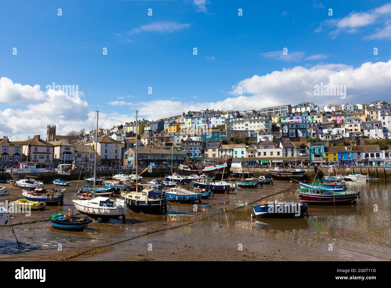 View of boats around the harbour side at the fishing port of Brixham ...