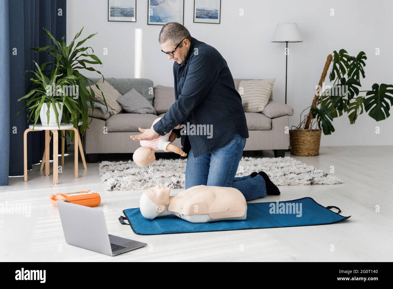 Paramedic demonstrating first aid on manikin during training alone in ...