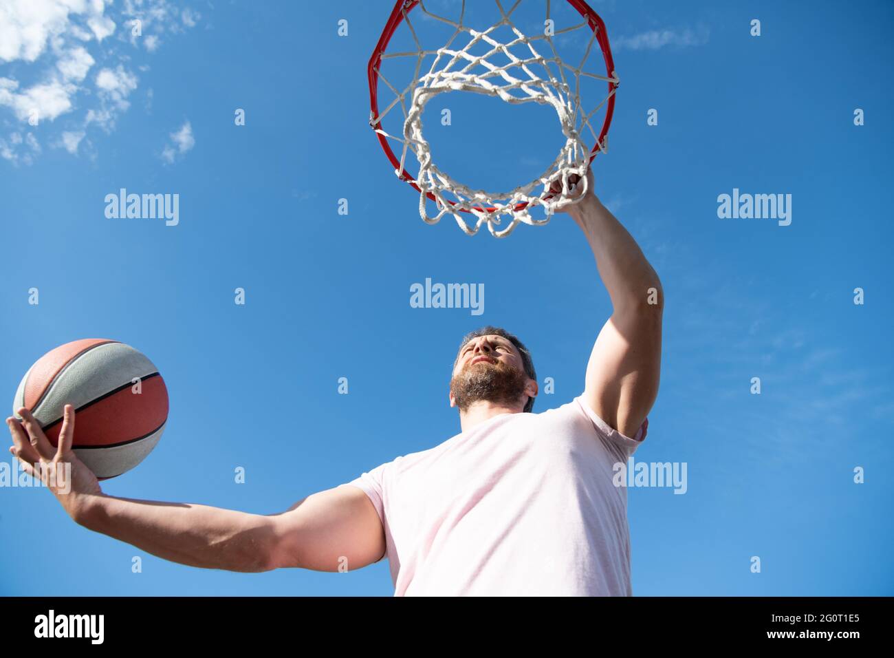 man play basketball outdoor. man jump to throw the ball. guy play ...