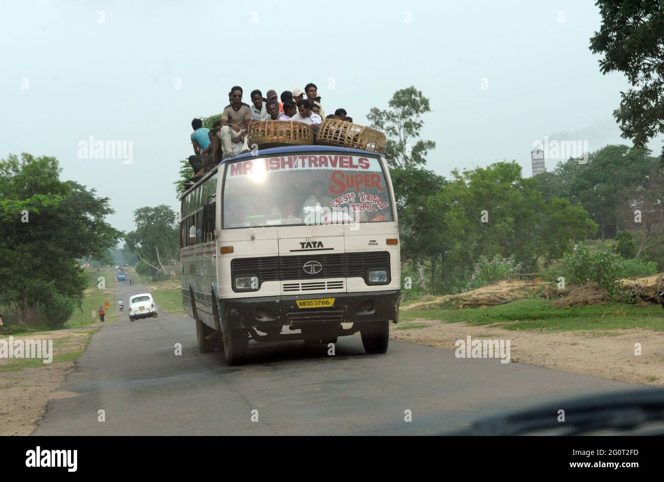 Passenger travel on the roof top of a bus to travel long distance on a ...