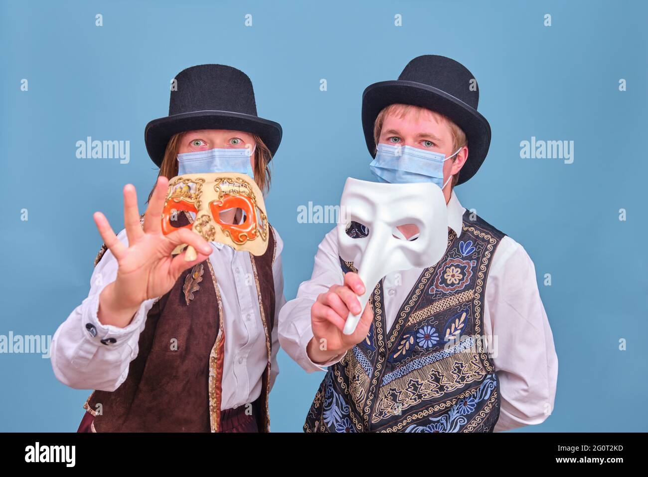 Actors wearing plague doctor masks on their faces, blue background ...