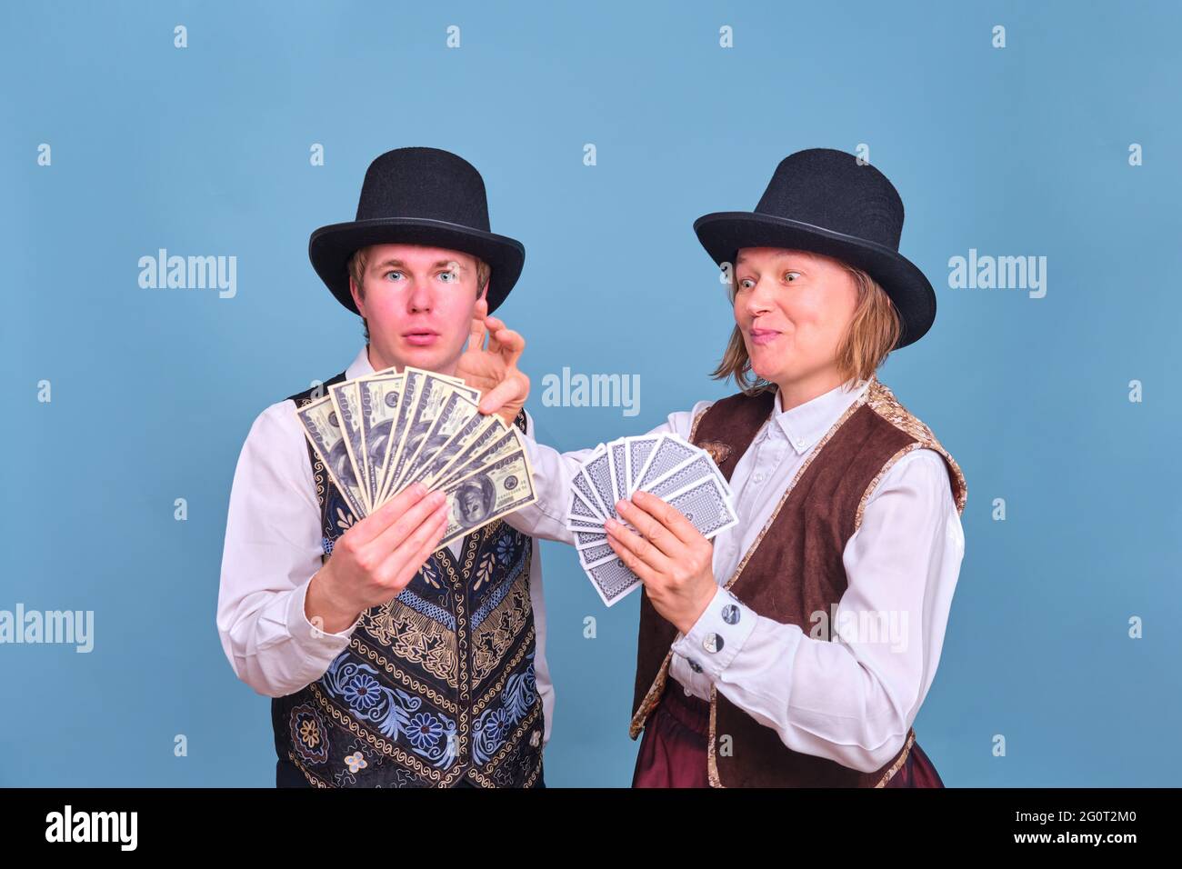 Actors man and woman with money dollars in hands on a blue background ...