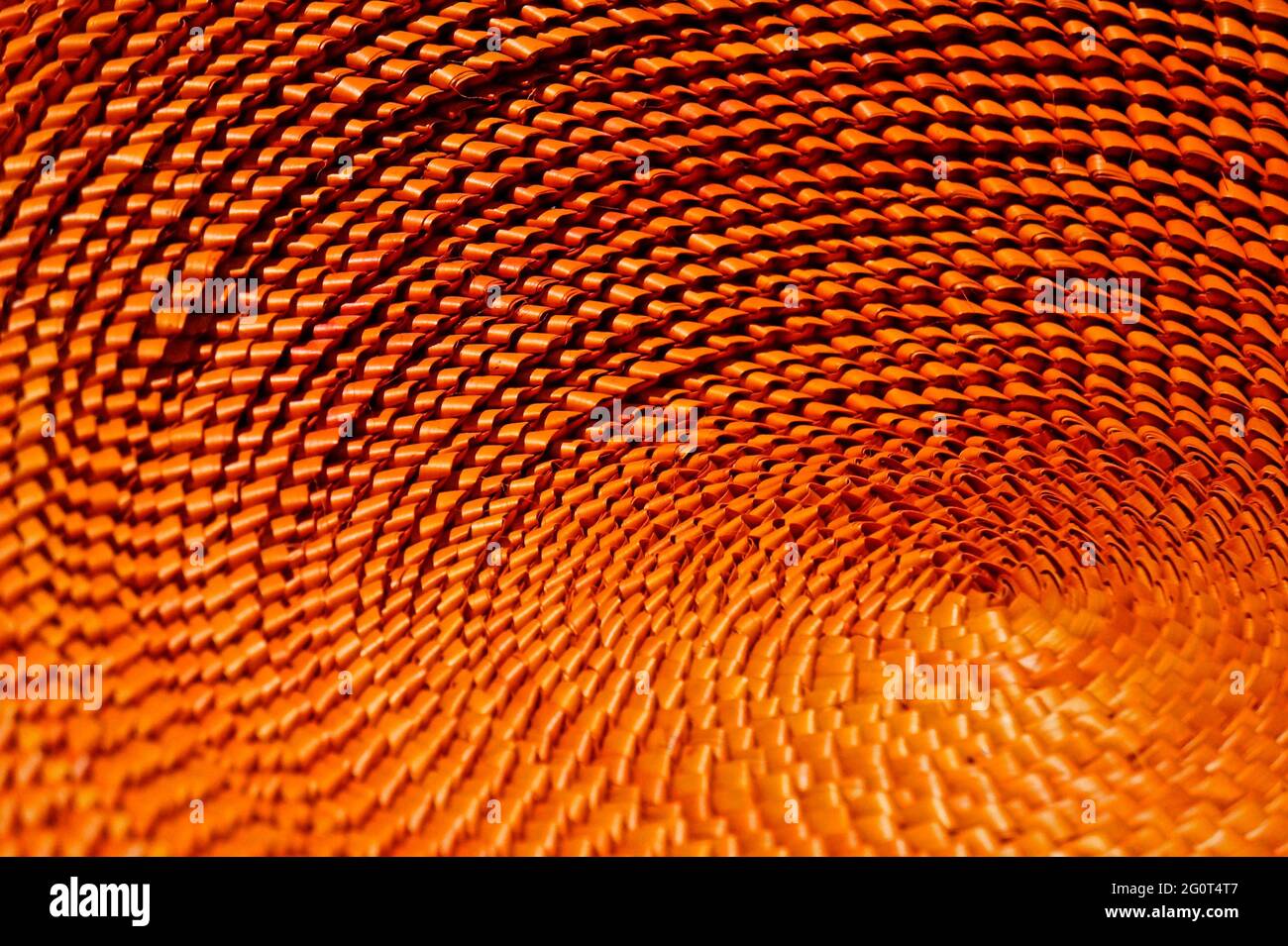 Handicraft with straw in orange Stock Photo - Alamy