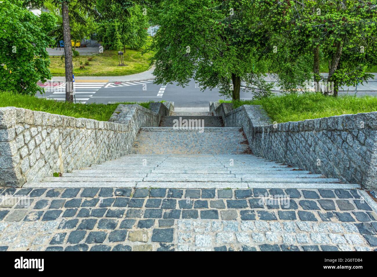 Fence and staircase made of granite stones. A cobbled area with a stone ...