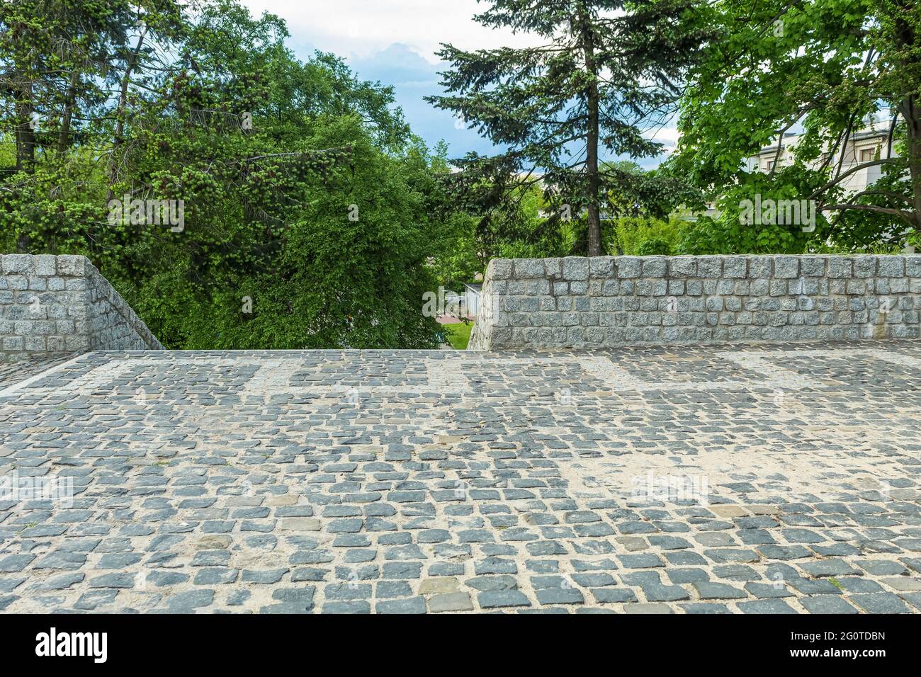 Fence and staircase made of granite stones. A cobbled area with a stone ...