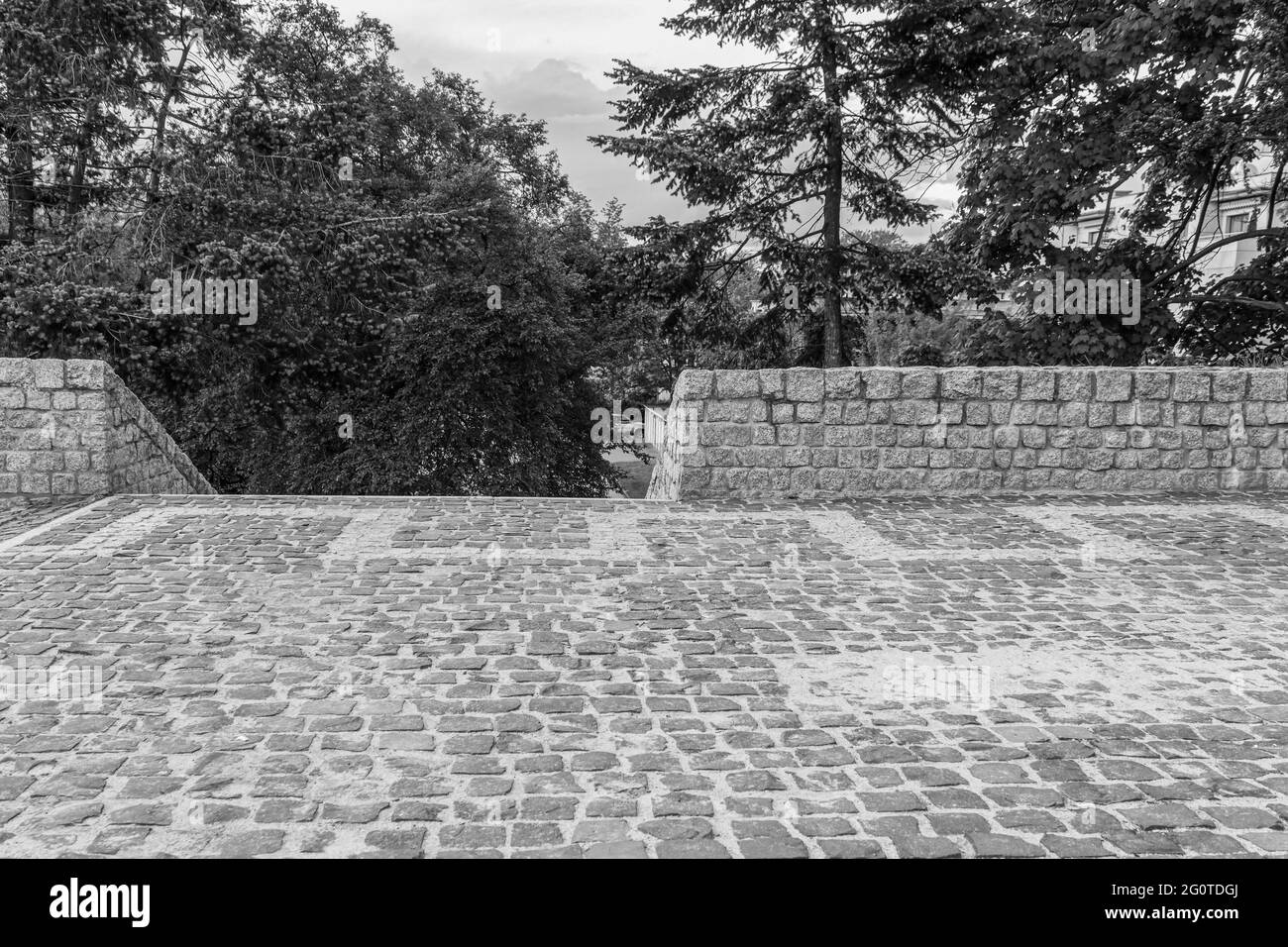 Fence and staircase made of granite stones. A cobbled area with a stone ...