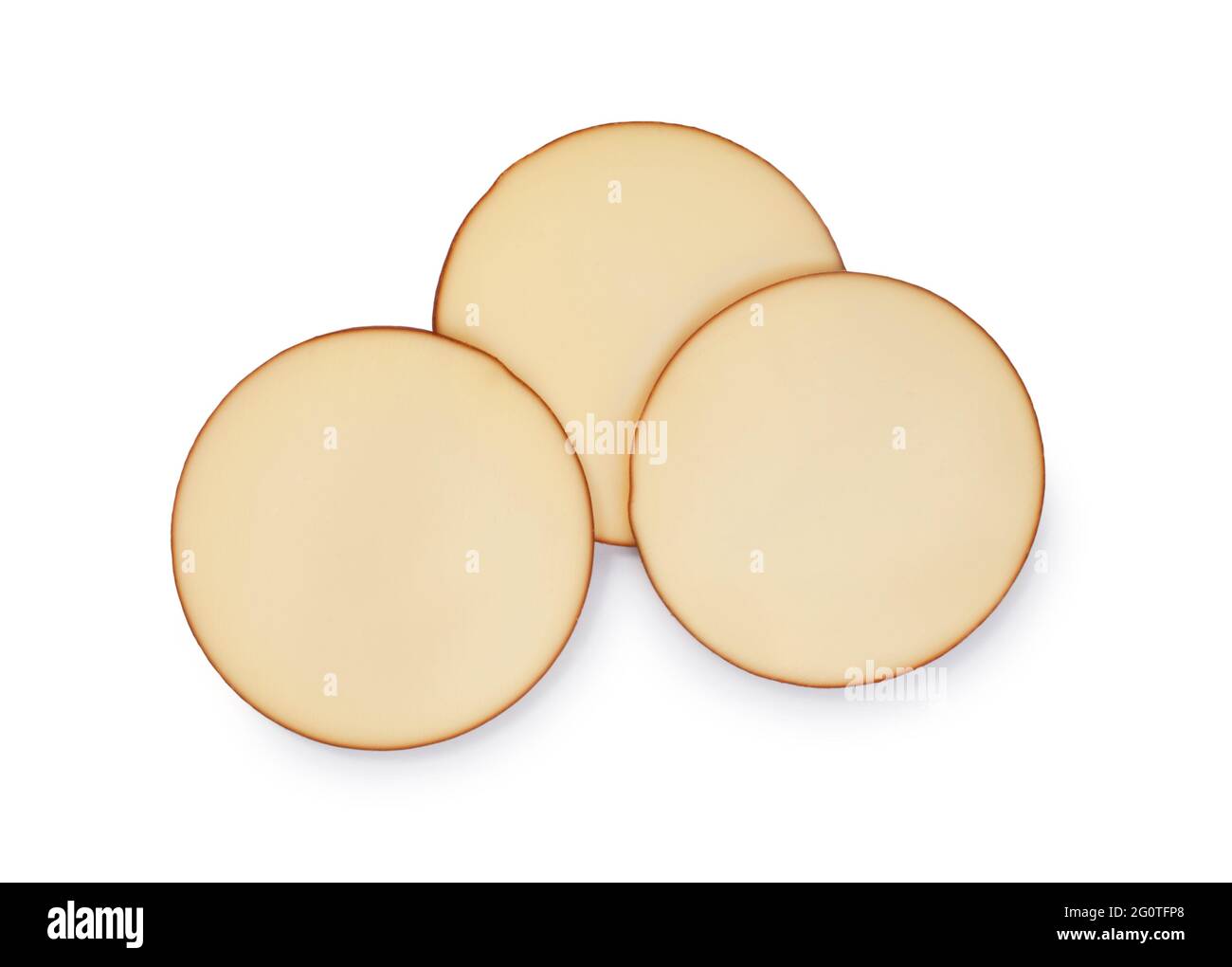Studio shot of circular slices of smoked cheese cut out against a white ...