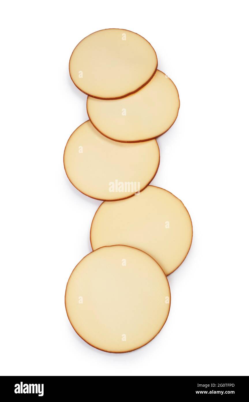 Studio shot of circular slices of smoked cheese cut out against a white ...