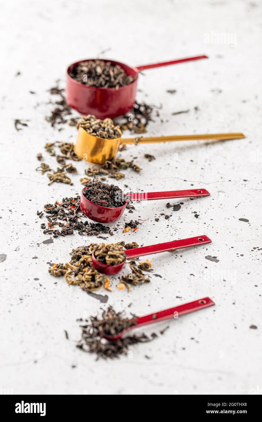 Set of different dry tea in measuring spoons Stock Photo - Alamy