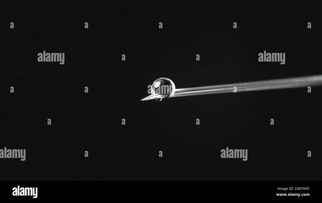 Photo of syringe needle with drop of clear solution Stock Photo - Alamy