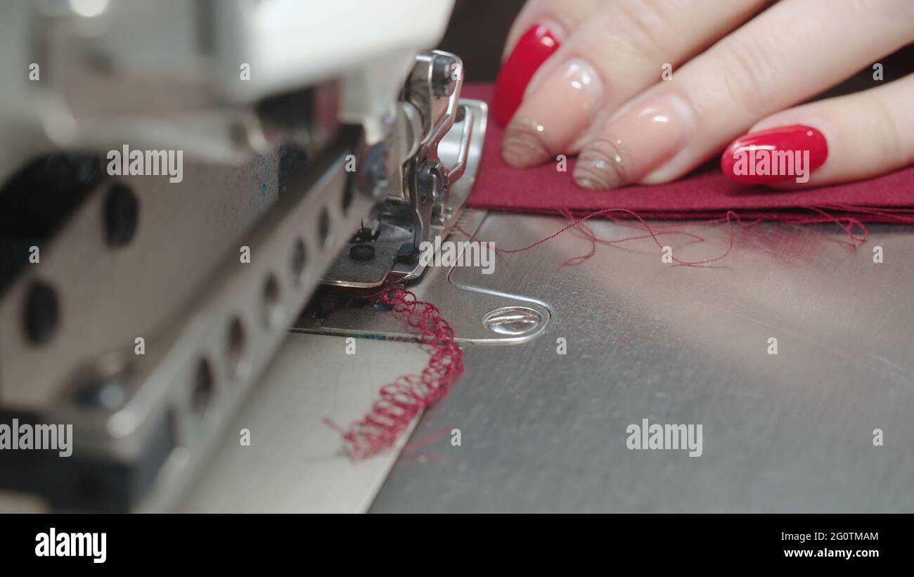 Photo of tailor sewing order on electric overlock Stock Photo - Alamy