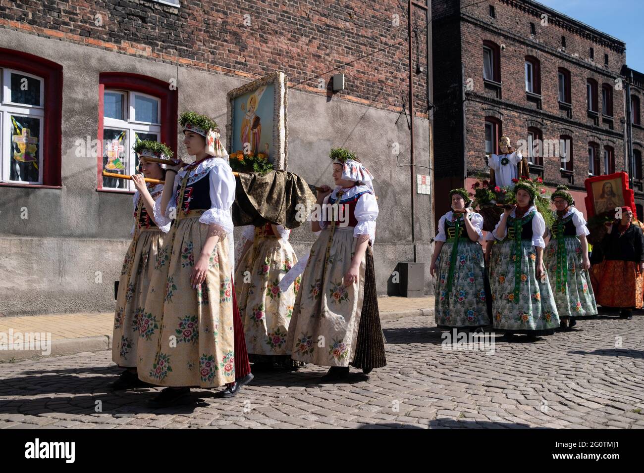 A procession of the faithful in traditional costumes carrying sacred ...