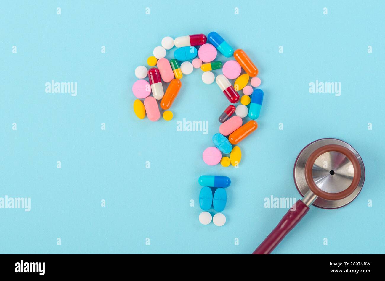 A question mark from laid out of medicine pills with stethoscope on ...