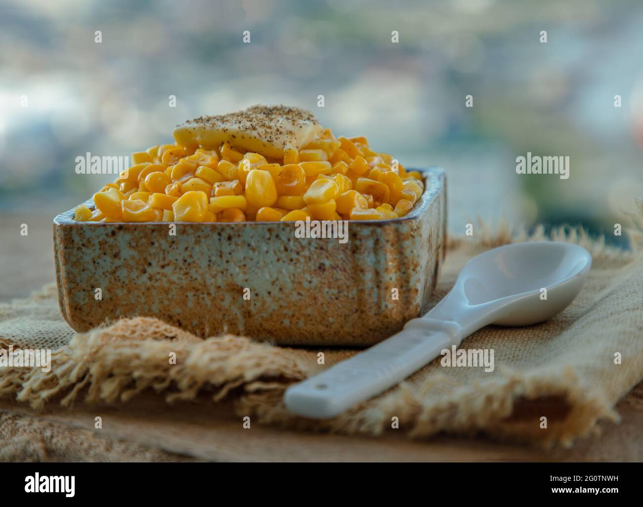 Fried sweet corn with a knob of butter and seasonings Sprinkle with ...