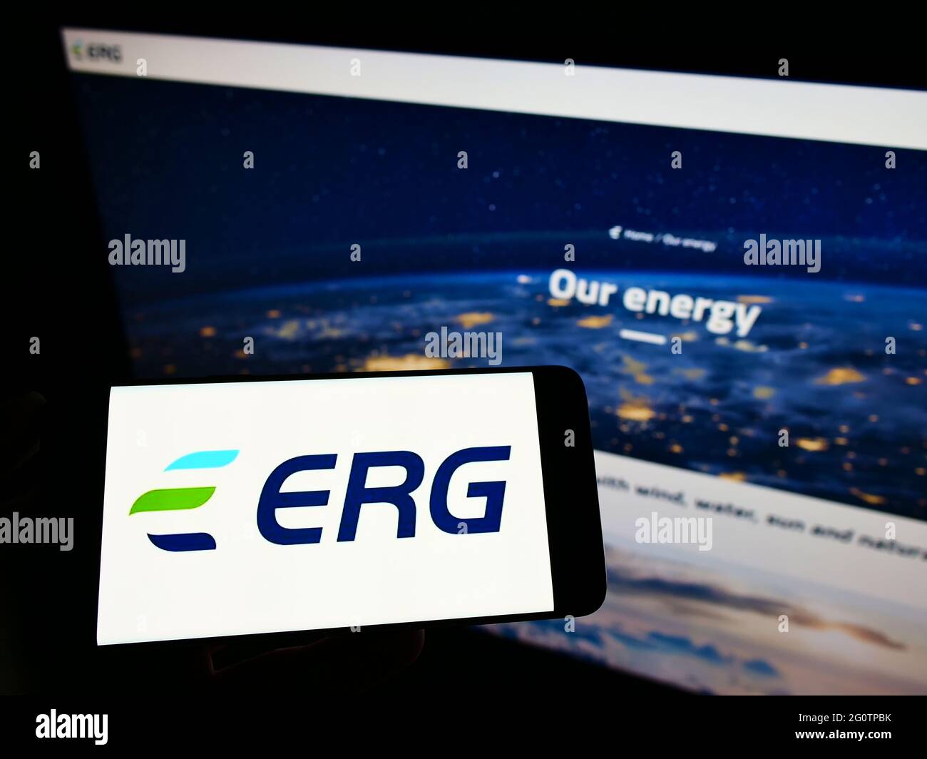 Person holding mobile phone with business logo of Italian energy ...